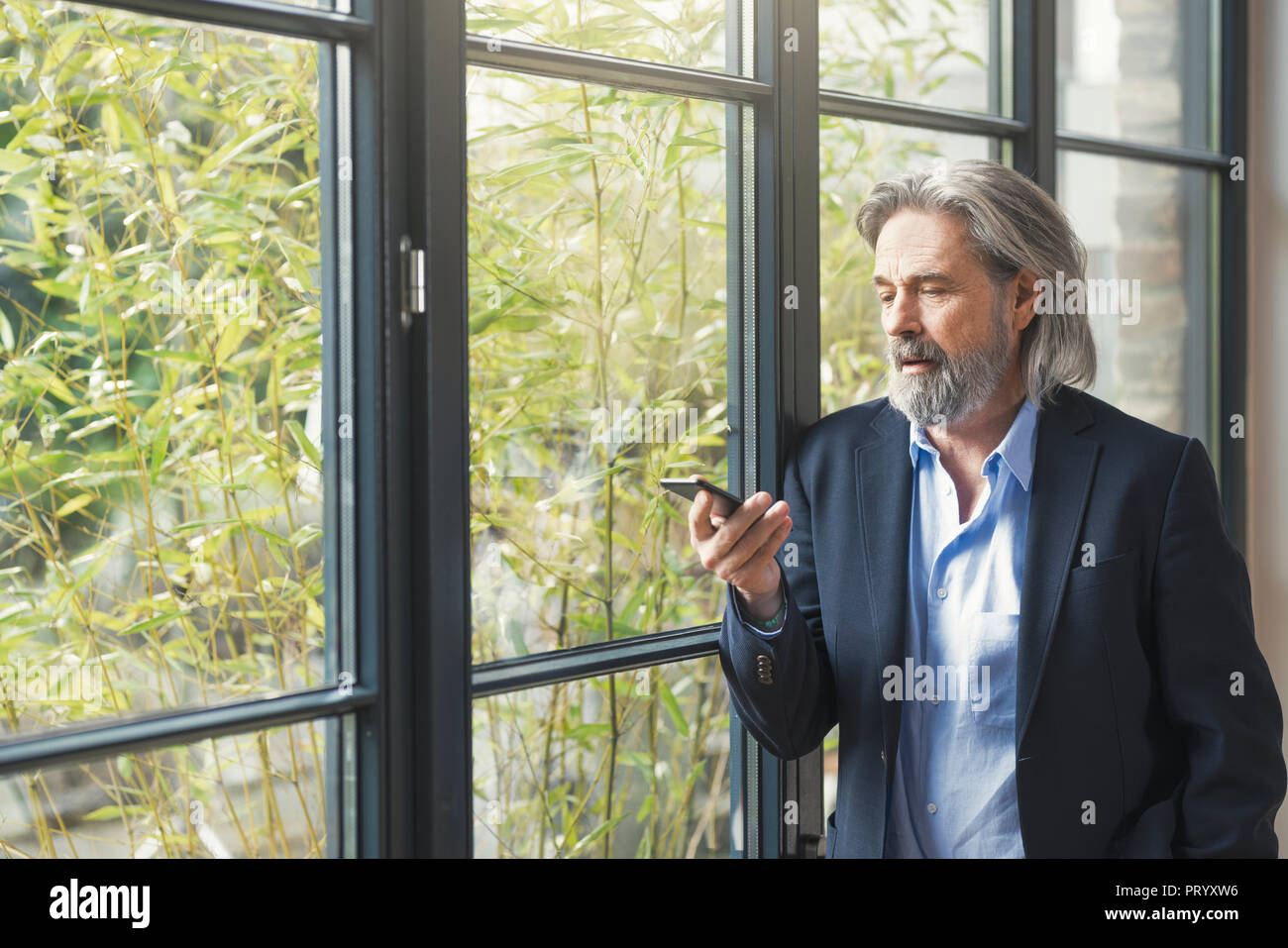 Standing at window of hi-res stock photography and images - Alamy