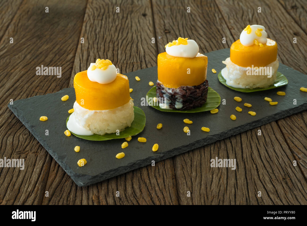 Mango on top of the sweet sticky rice topping with coconut cream and ...