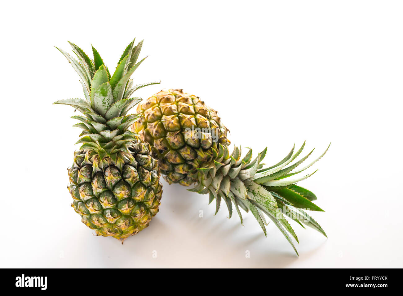 Two Thai pineapples isolated on white background Stock Photo - Alamy