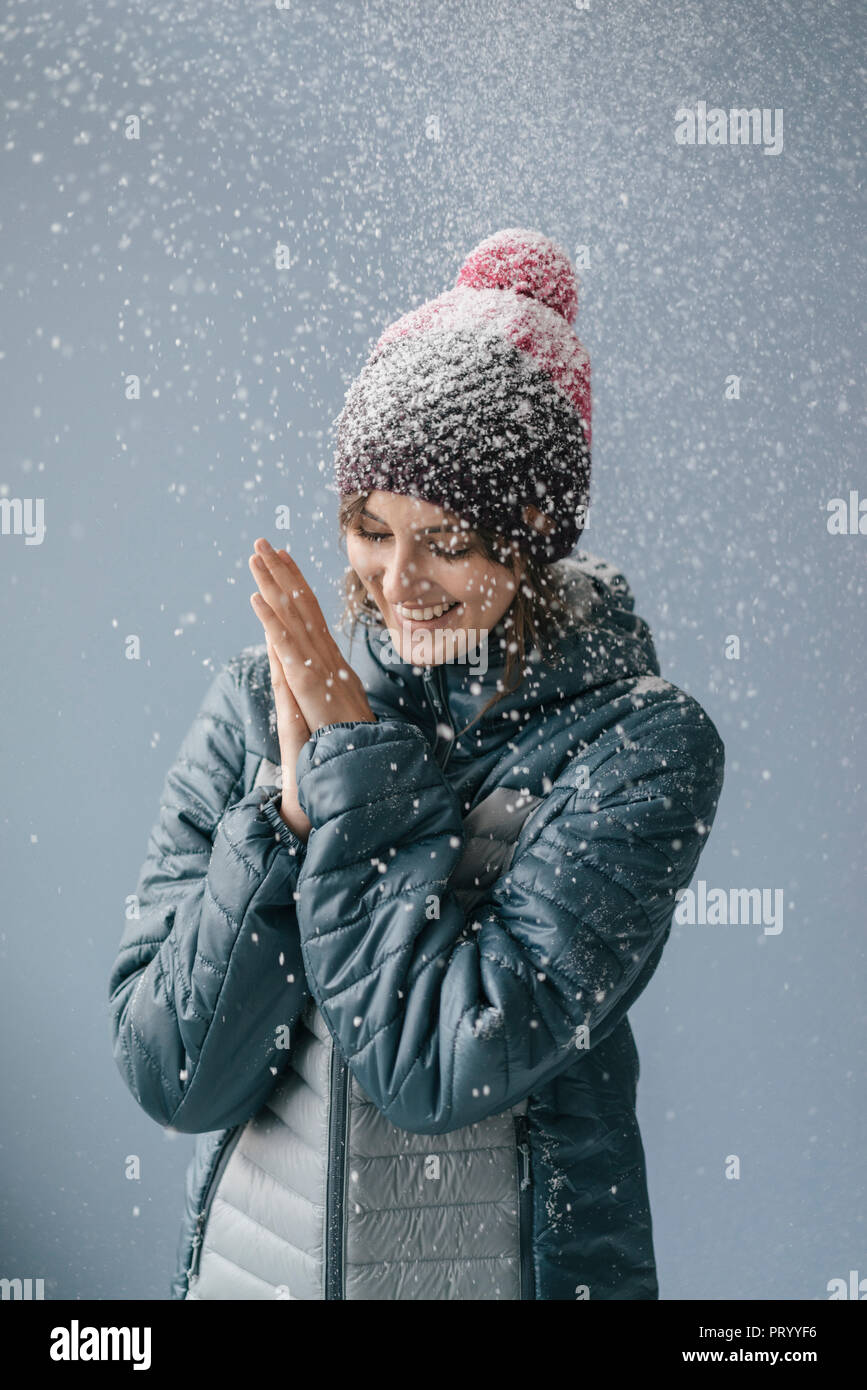 Woman wearing woolly hat in snow, portrait Stock Photo - Alamy