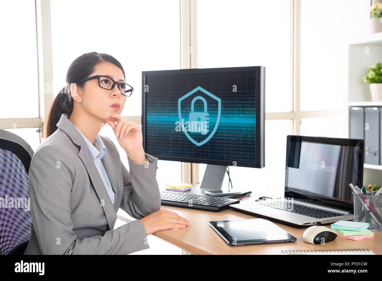 female cyber security company employee thinking how to solve internet ...