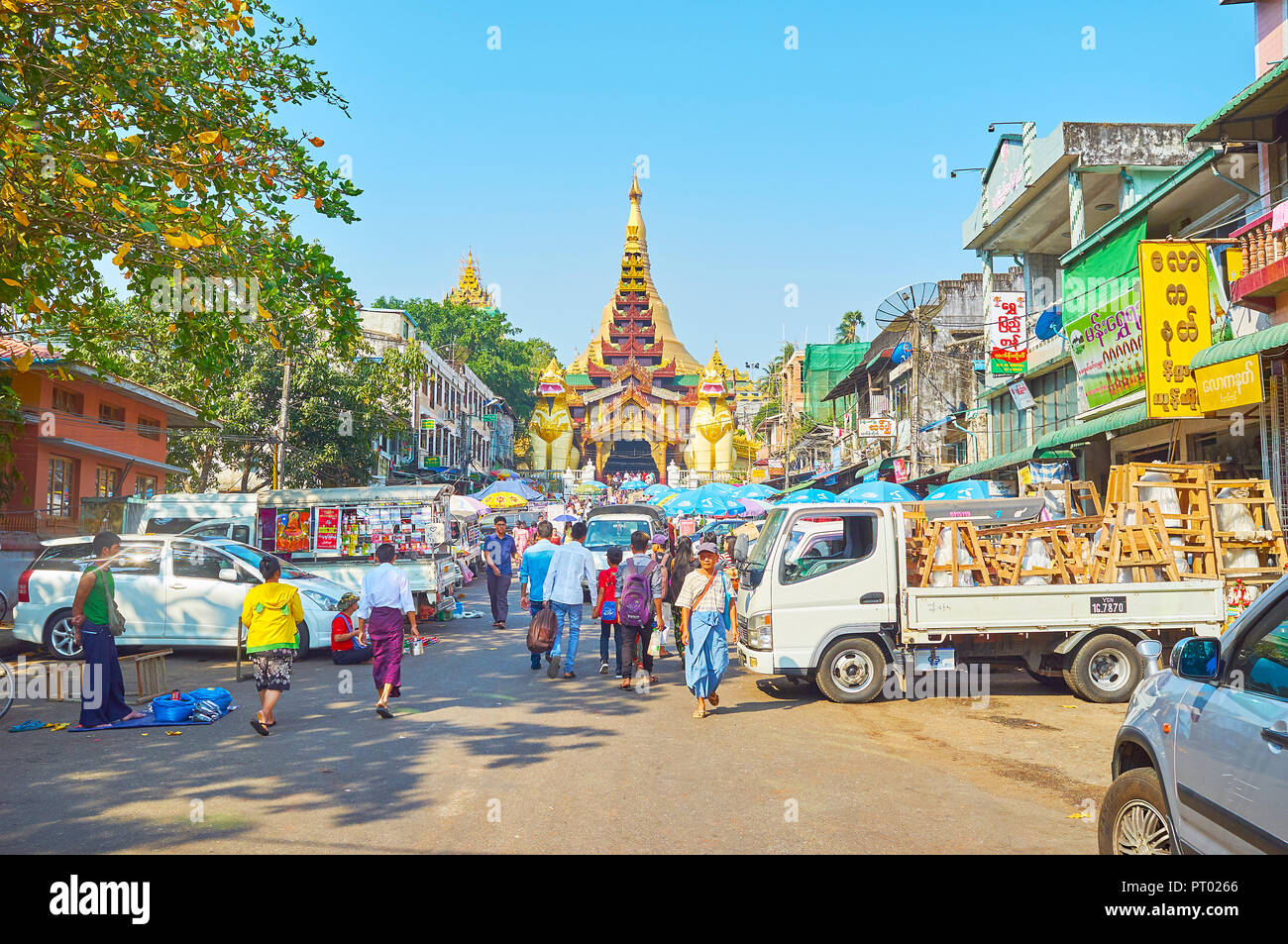 YANGON, MYANMAR - FEBRUARY 27, 2018: The busy market in front of the ...