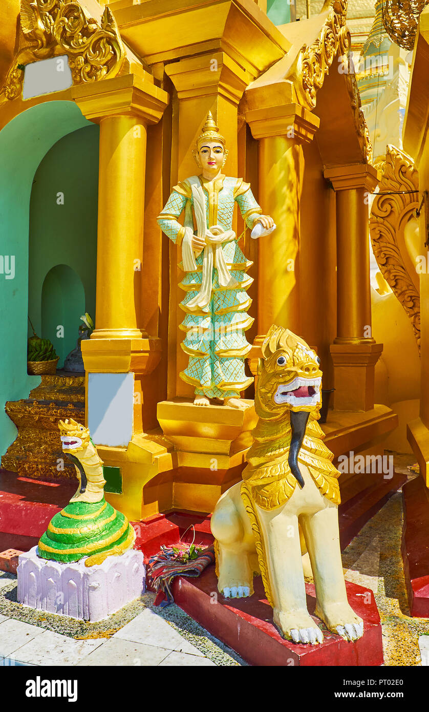 The group of religious statues at the small outer stupa of Shwedagon ...