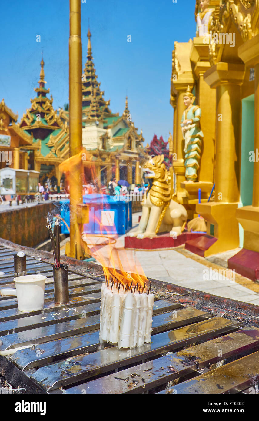 The altar along the circle alley of Shwedagon Zedi Daw with burning ...