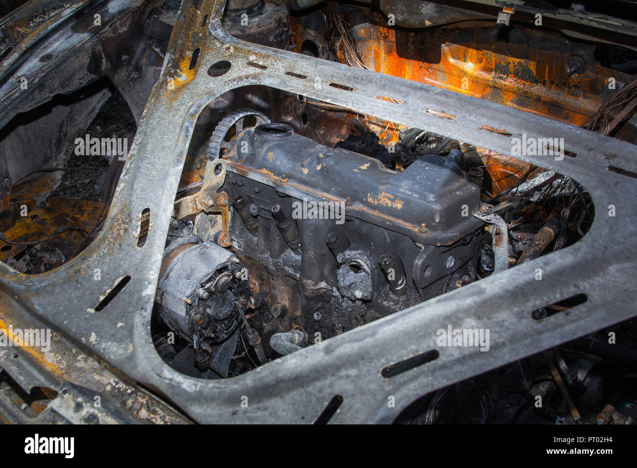 Engine of fully burned car in the forest in summer, accident background ...