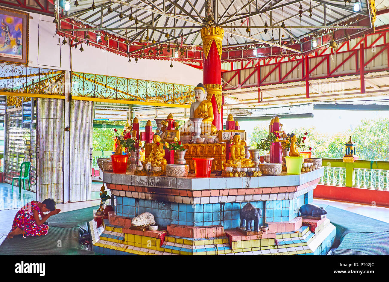 YANGON, MYANMAR - FEBRUARY 27, 2018: The circle altar with sculptures ...