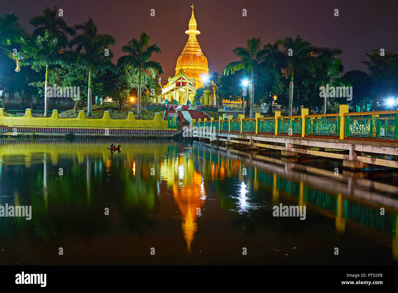 The evening walk at the ponds of Mahavijaya Pagoda with view on garden ...