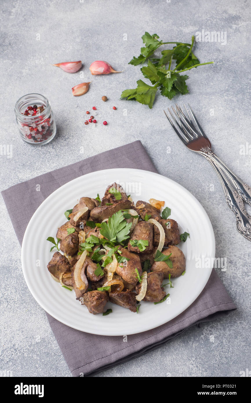 Baked chicken liver with onion on a plate Stock Photo - Alamy