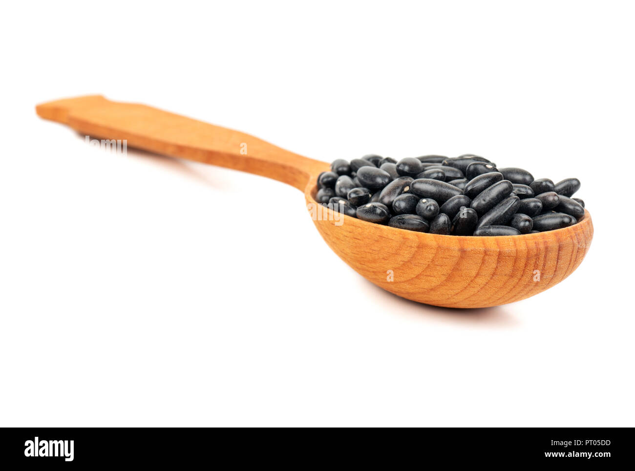 Wooden spoon with black beans isolated on white background Stock Photo ...