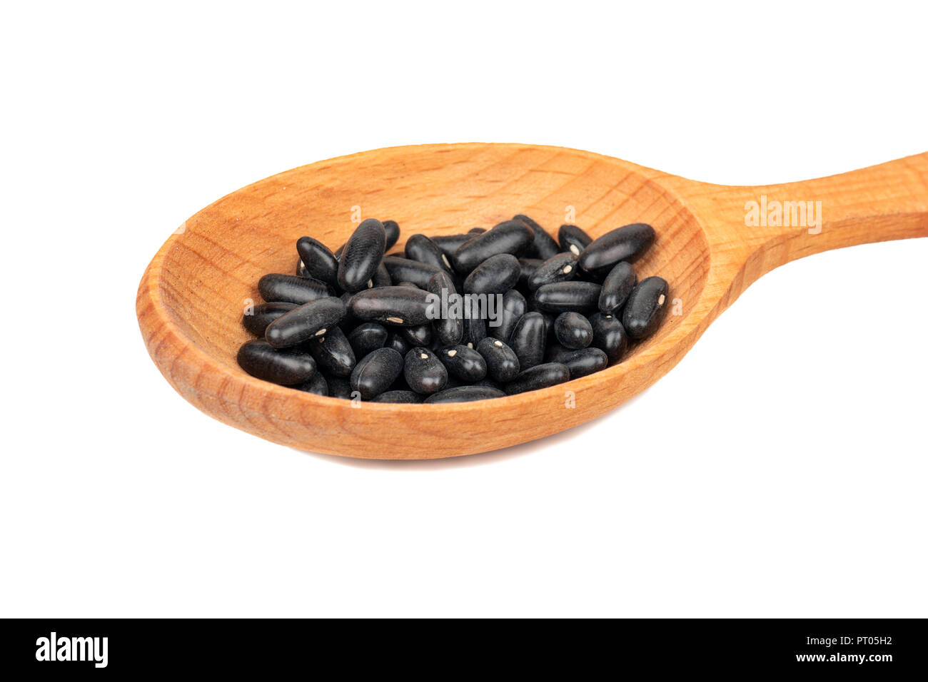 Large wooden spoon with black beans on white background close-up Stock ...