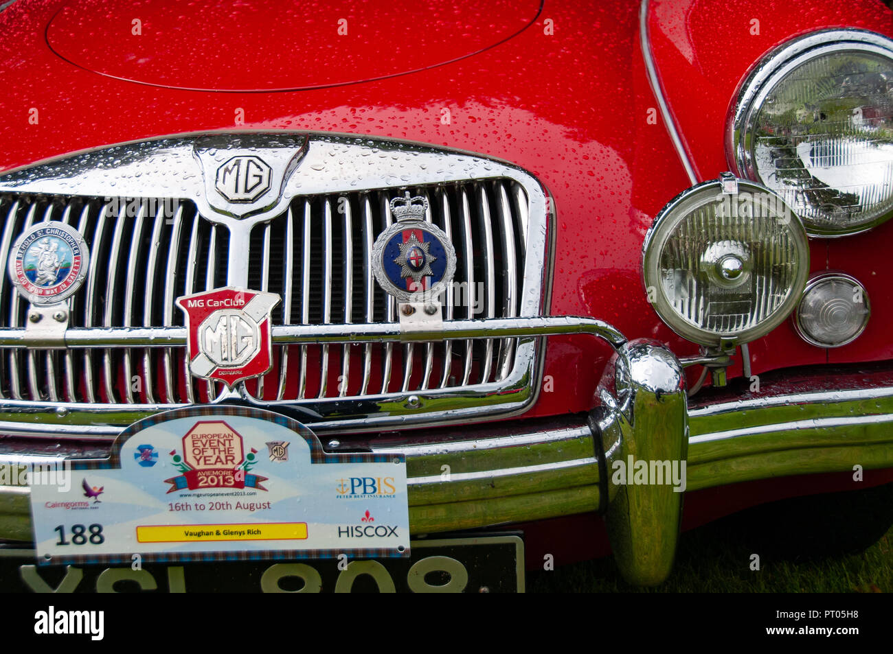 Front bonnet and radiator grill of bright red MG sports car showing ...