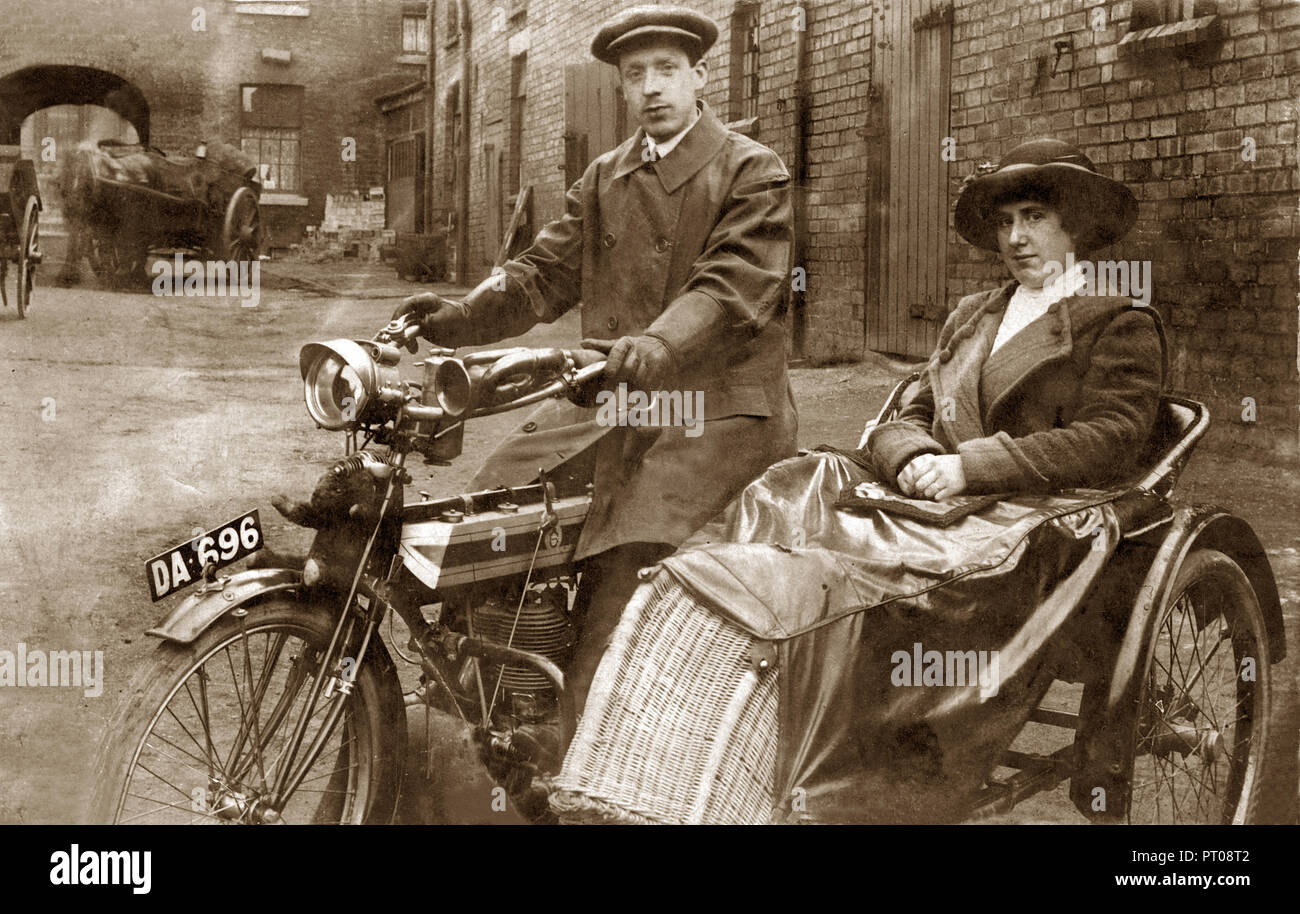 Lady & gentleman sitting on a 1910 Triumph motorcycle combination circa ...