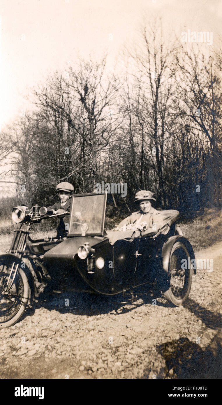 Little boy on 1920 Royal Enfield motorcycle with lady passenger in ...