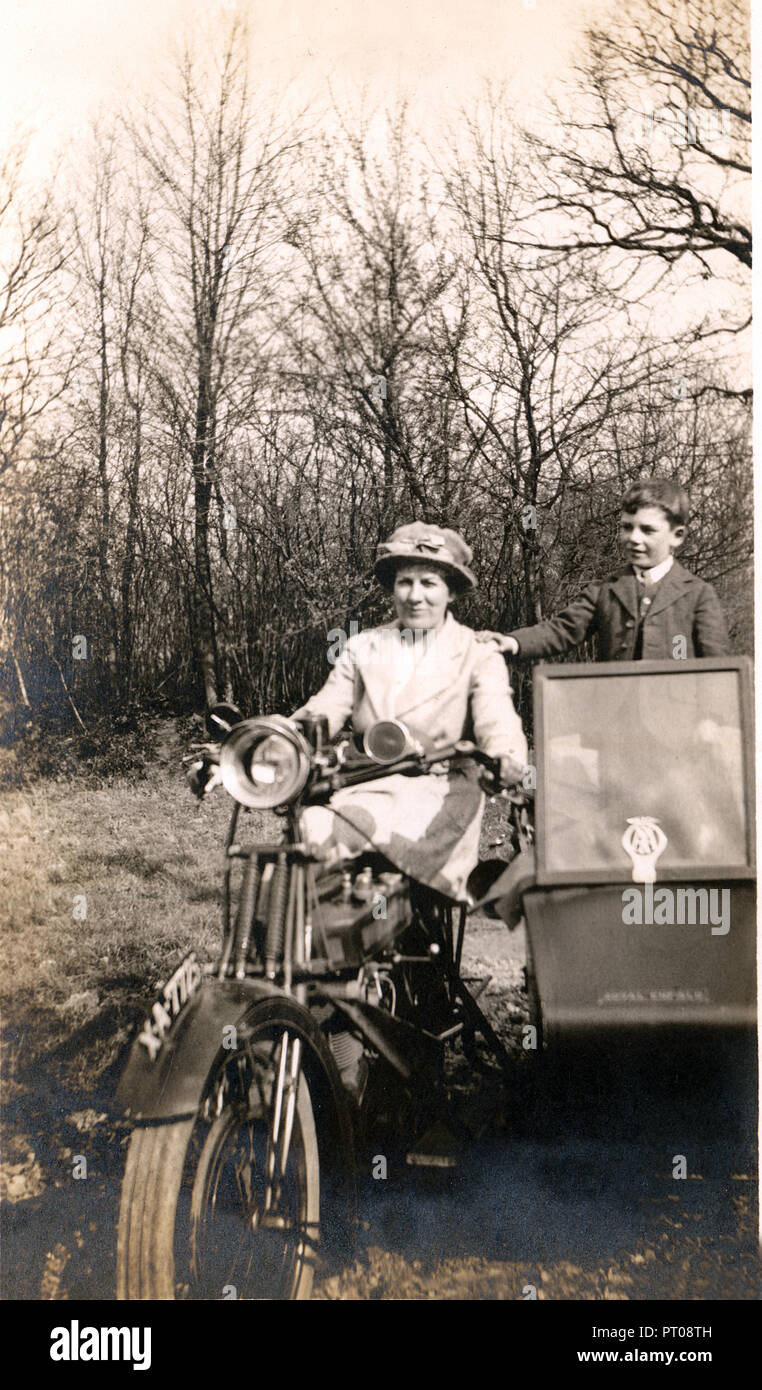 Lady on 1920 Royal Enfield motorcycle with little boy passenger in ...