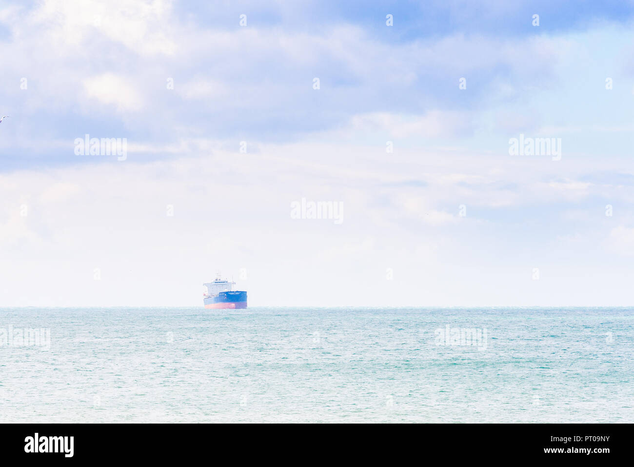 Ship in the distance through sea mist Stock Photo - Alamy