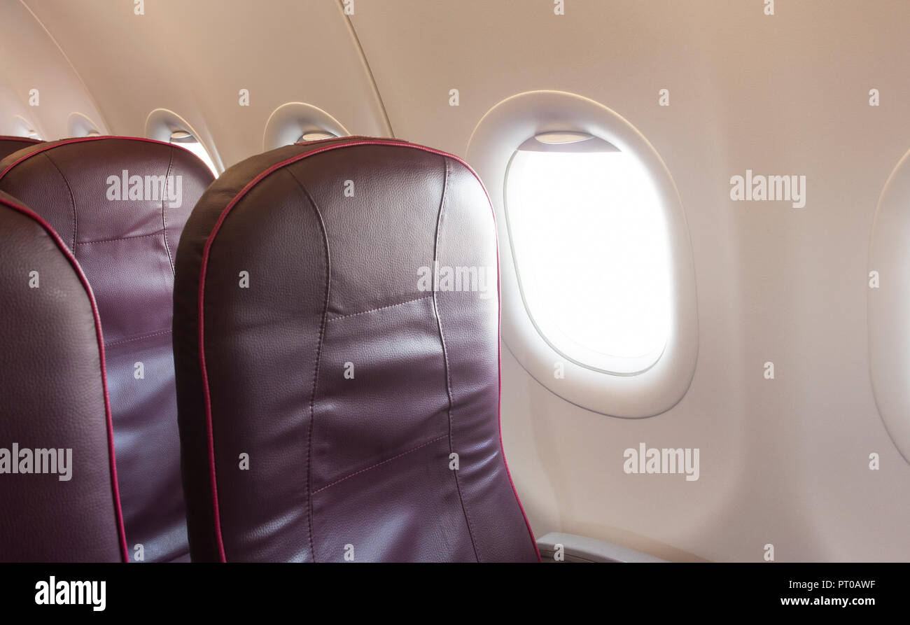 interior of airplane with chair and white window Stock Photo - Alamy