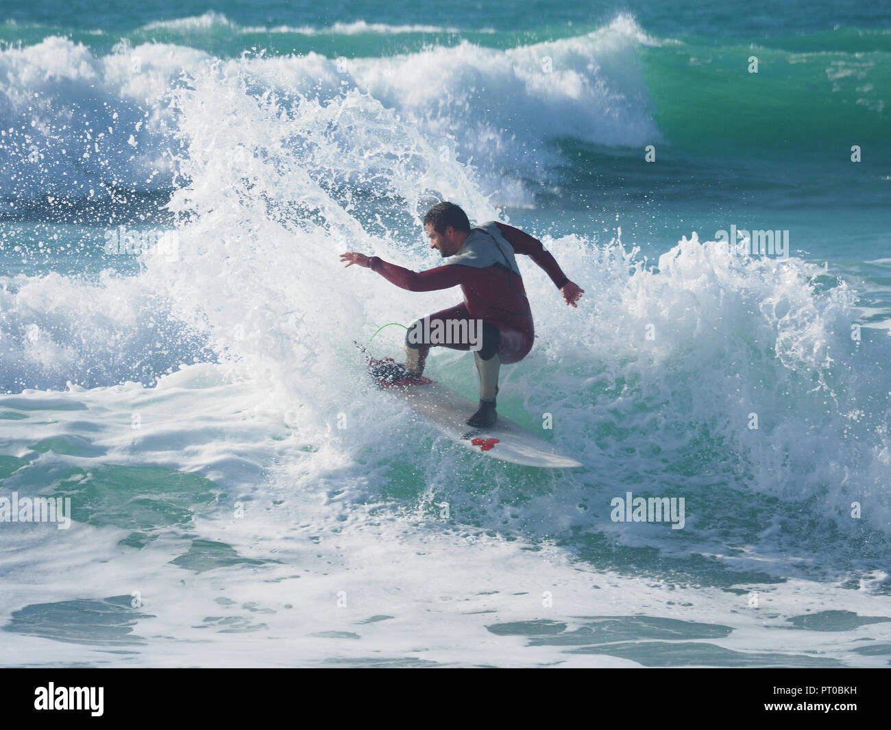 Experienced white male wetsuit surfer Stock Photo - Alamy