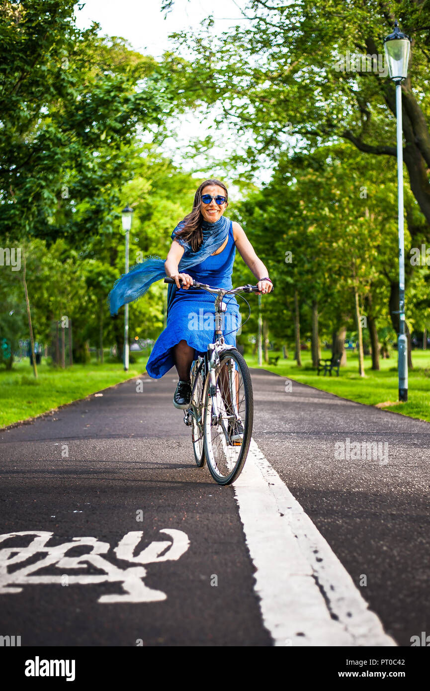 Girl with dress riding bike hi-res stock photography and images - Alamy