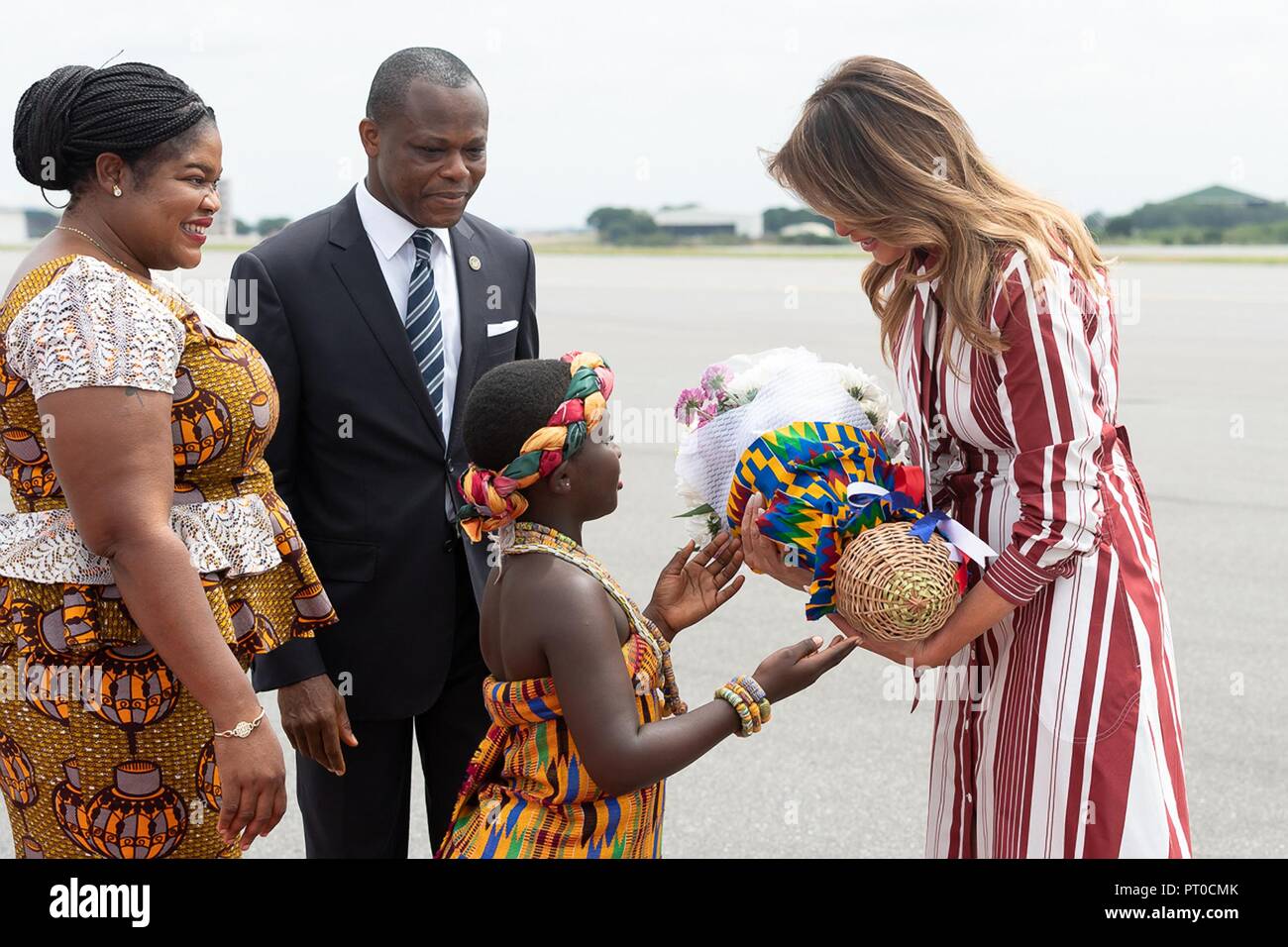 U.S First Lady Melania Trump is presented with flowers on arrival to ...