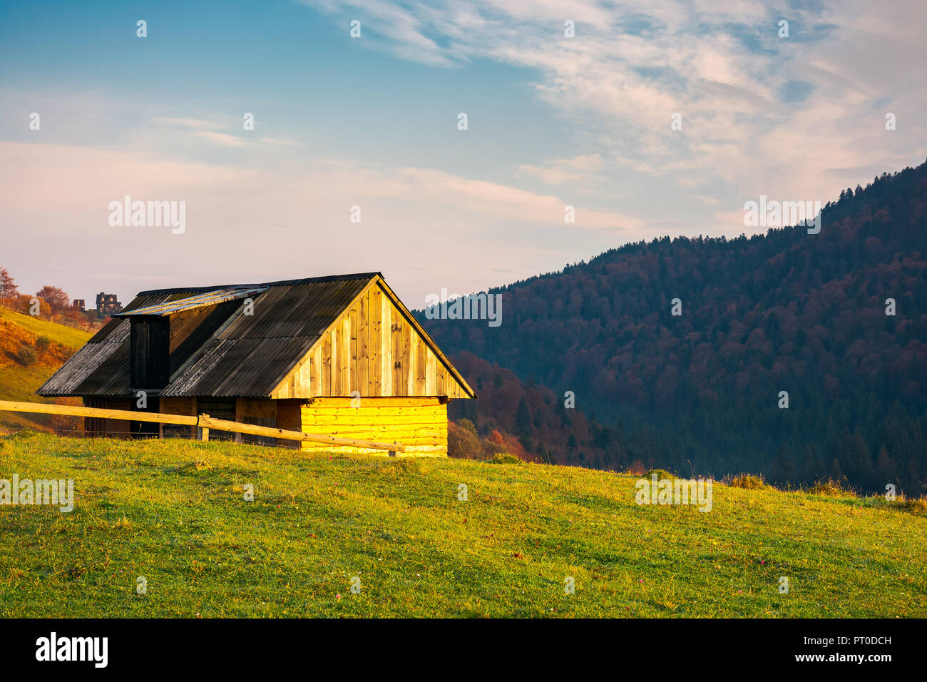 wooden barn in village outskirts on hill in morning light. beautiful ...