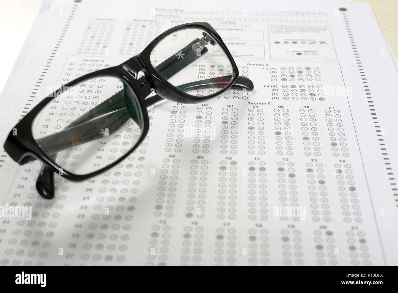 Glasses on omr sheet. Exam omr sheet circles is filled with pencil ...
