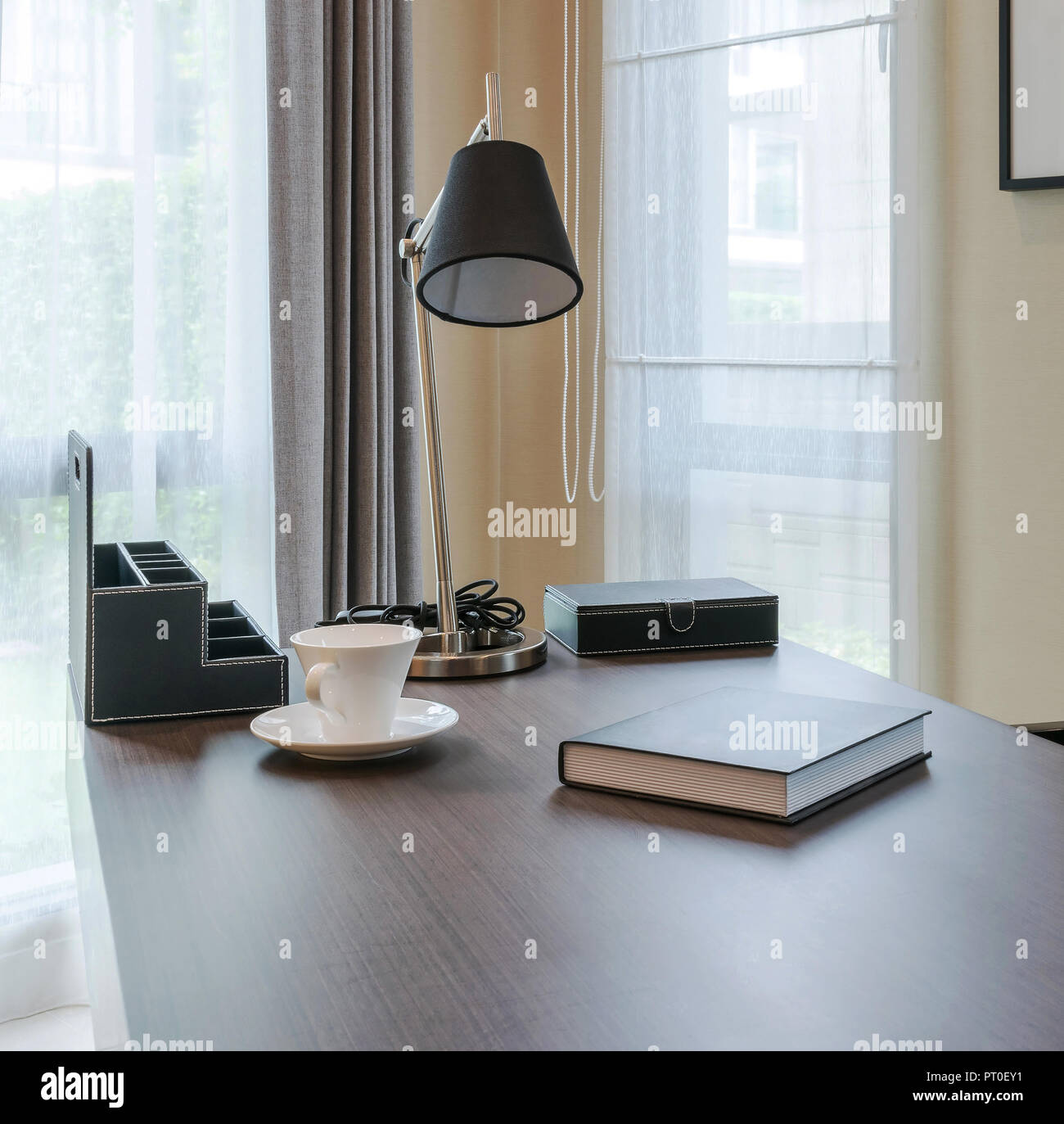 wooden table and books in modern working room interior Stock Photo - Alamy