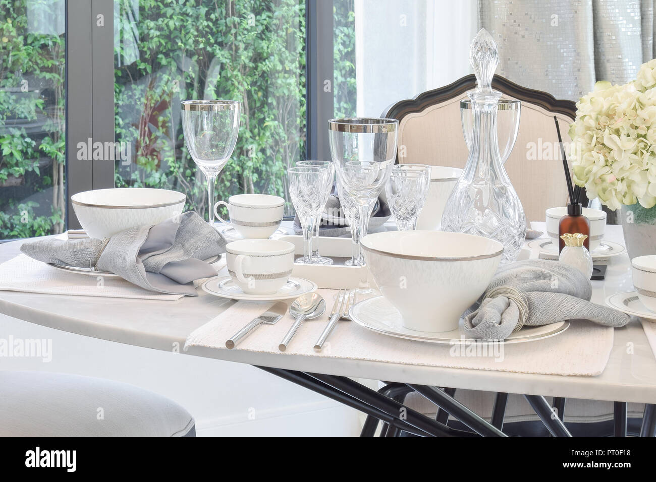 dining table in modern home with elegant table setting Stock Photo - Alamy