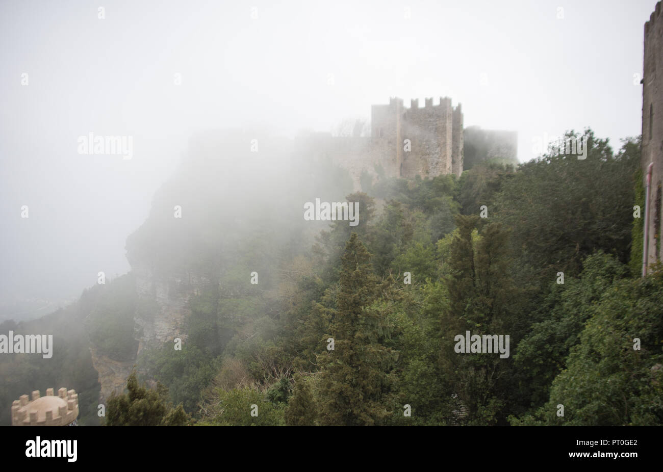 Beautiful medieval castle on a hilltop half covered with clouds Stock ...