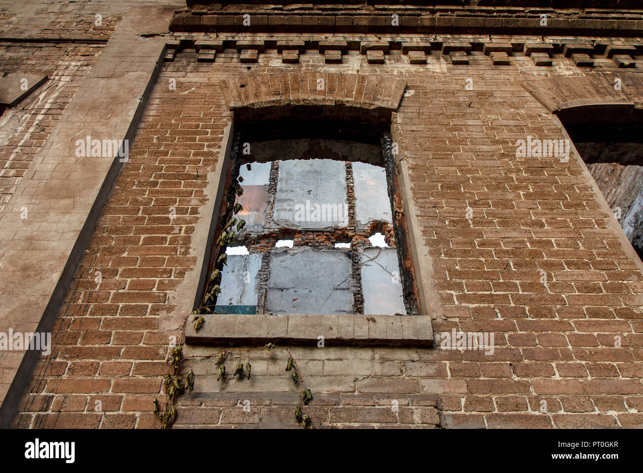 Facade of old abandoned brick building with empty window opening Stock ...