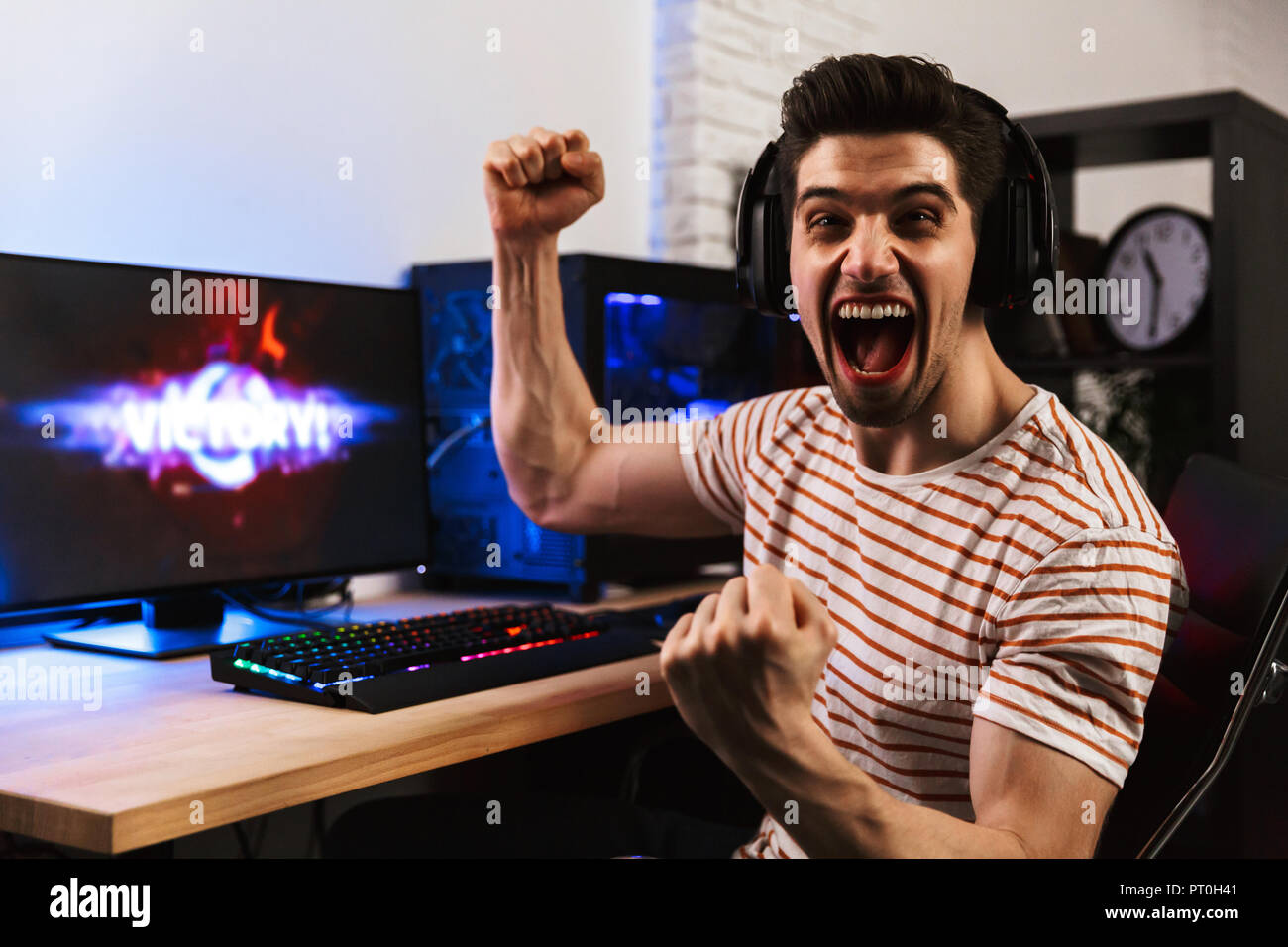 Portrait of caucasian gamer guy screaming and rejoicing while playing ...