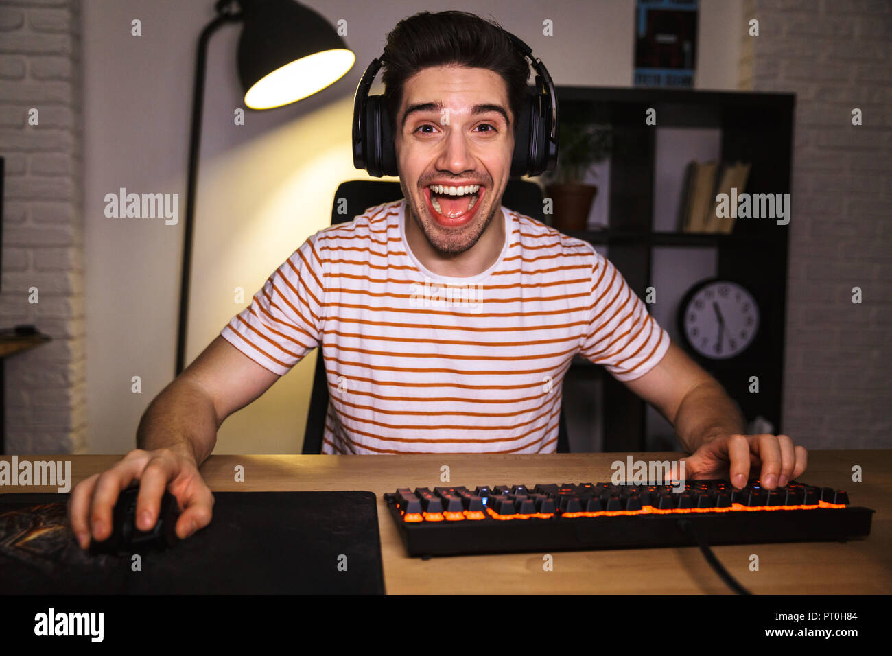 Portrait of caucasian guy wearing headphones smiling while looking on ...