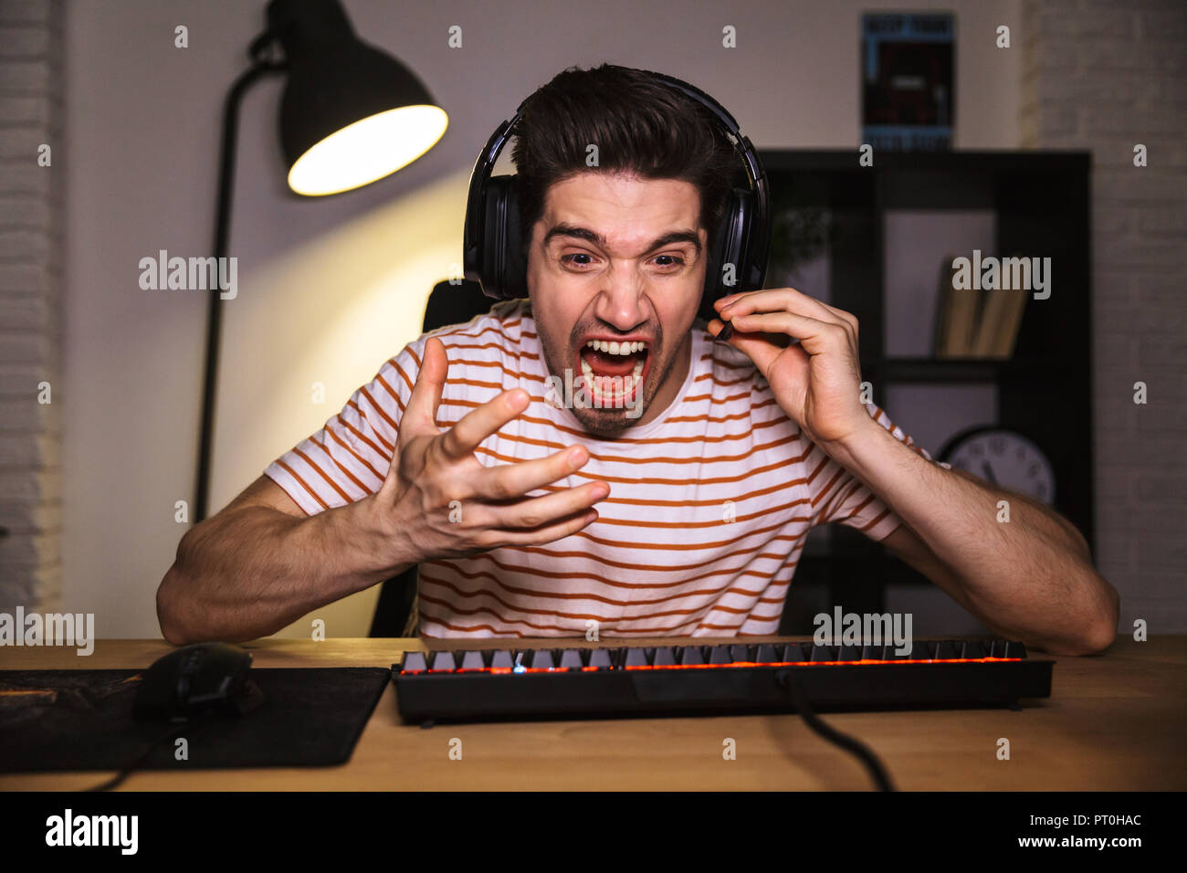 Portrait of stressed young man 20s wearing headset yelling while ...