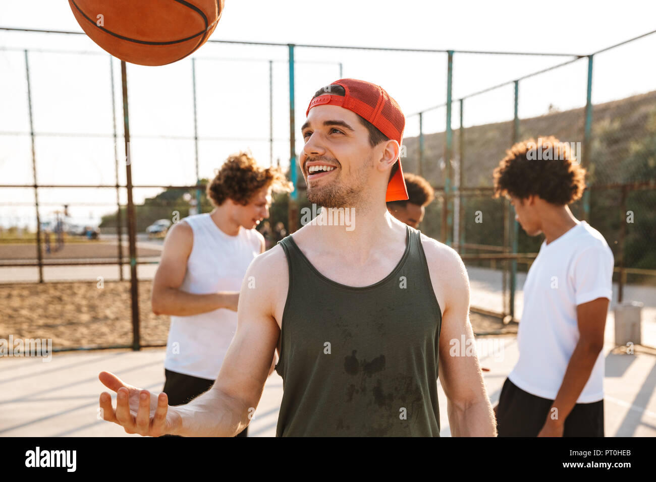 Group of multhiethnic smiling young men at the basketball field Stock ...