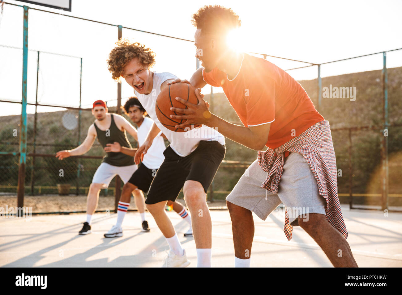 Group of young strong multiethnic men basketball players playing ...