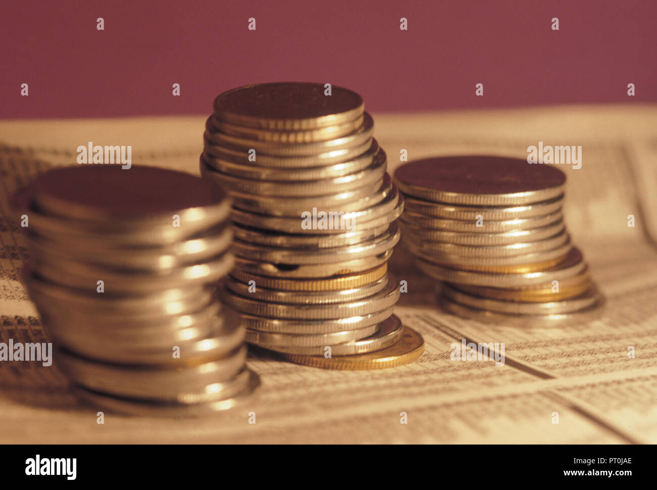 coins on a newspaper Stock Photo - Alamy