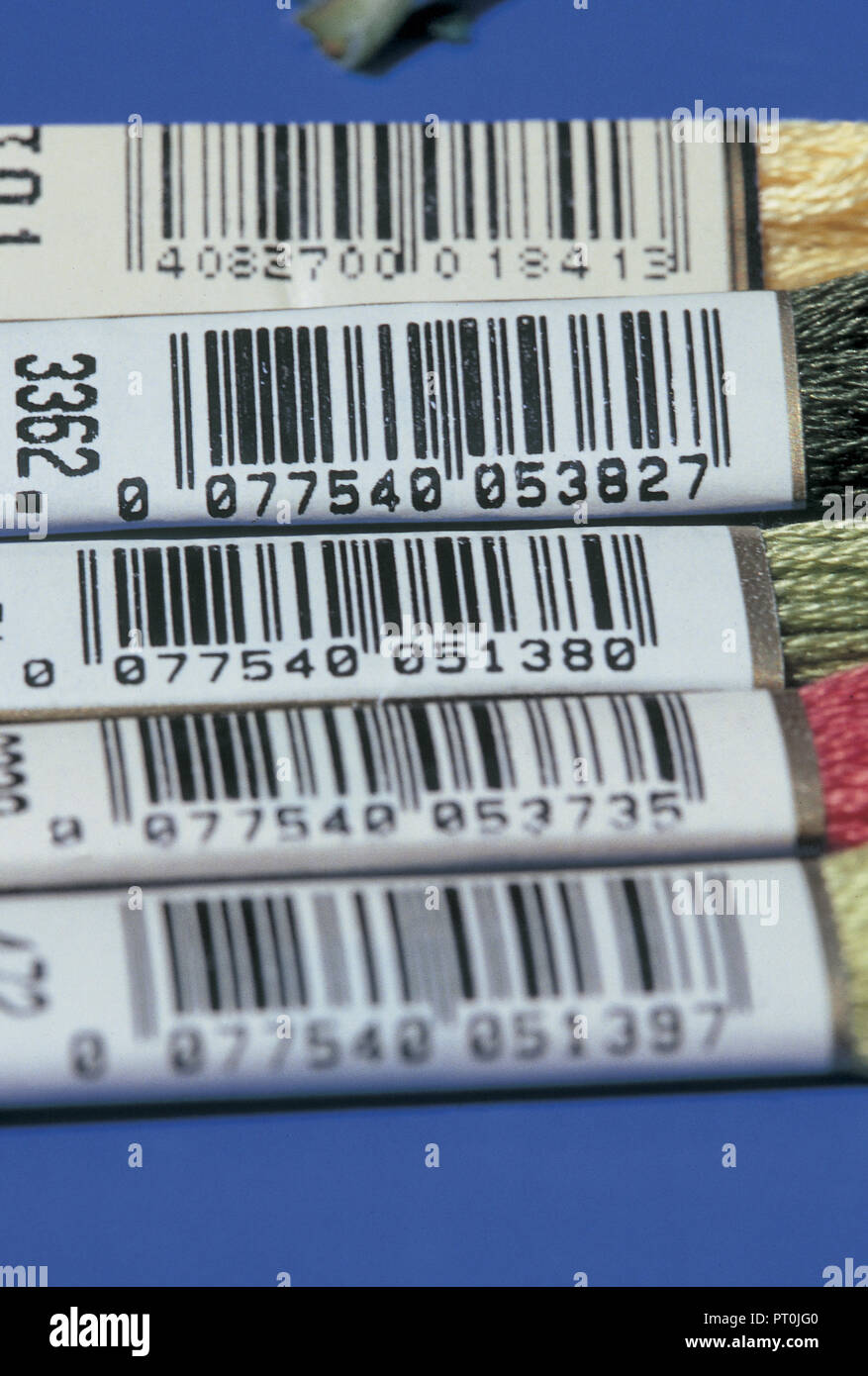 bar codes on reels of coloured thread Stock Photo - Alamy