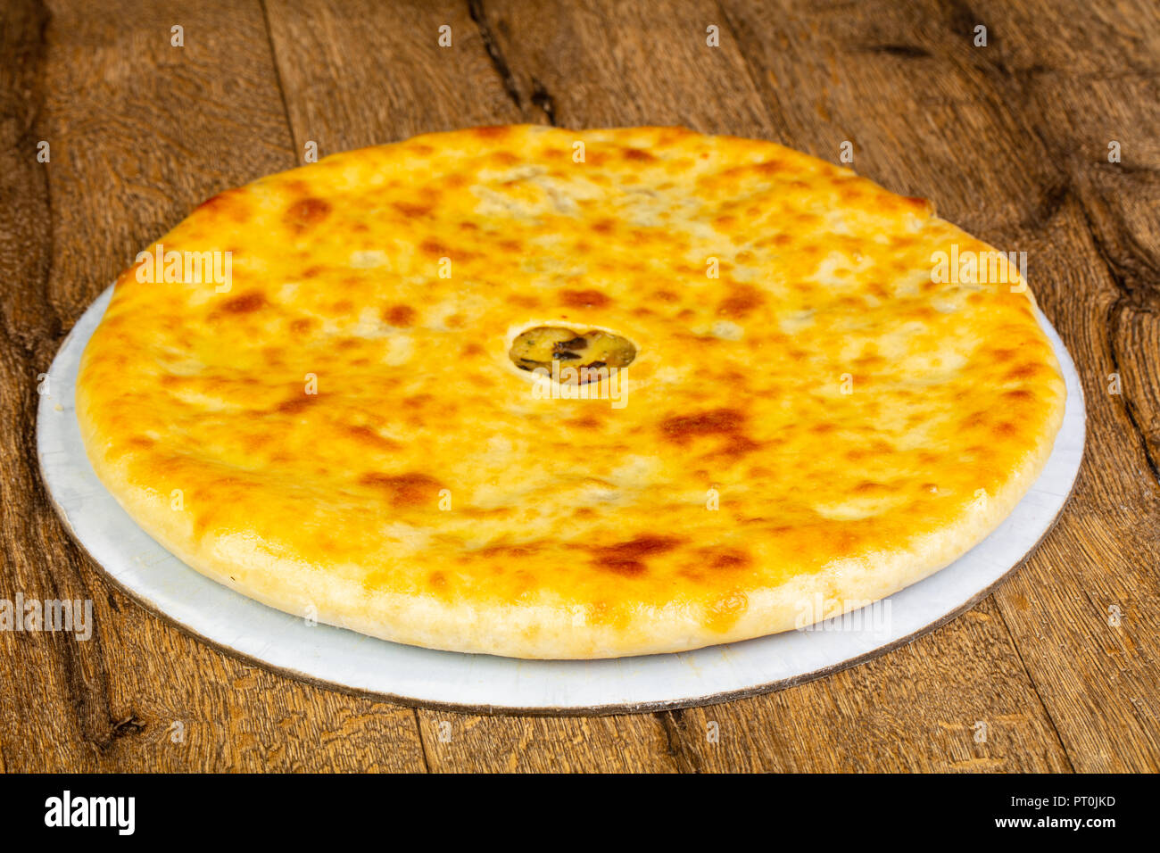 Traditional Ossetian pie over wooden background Stock Photo - Alamy