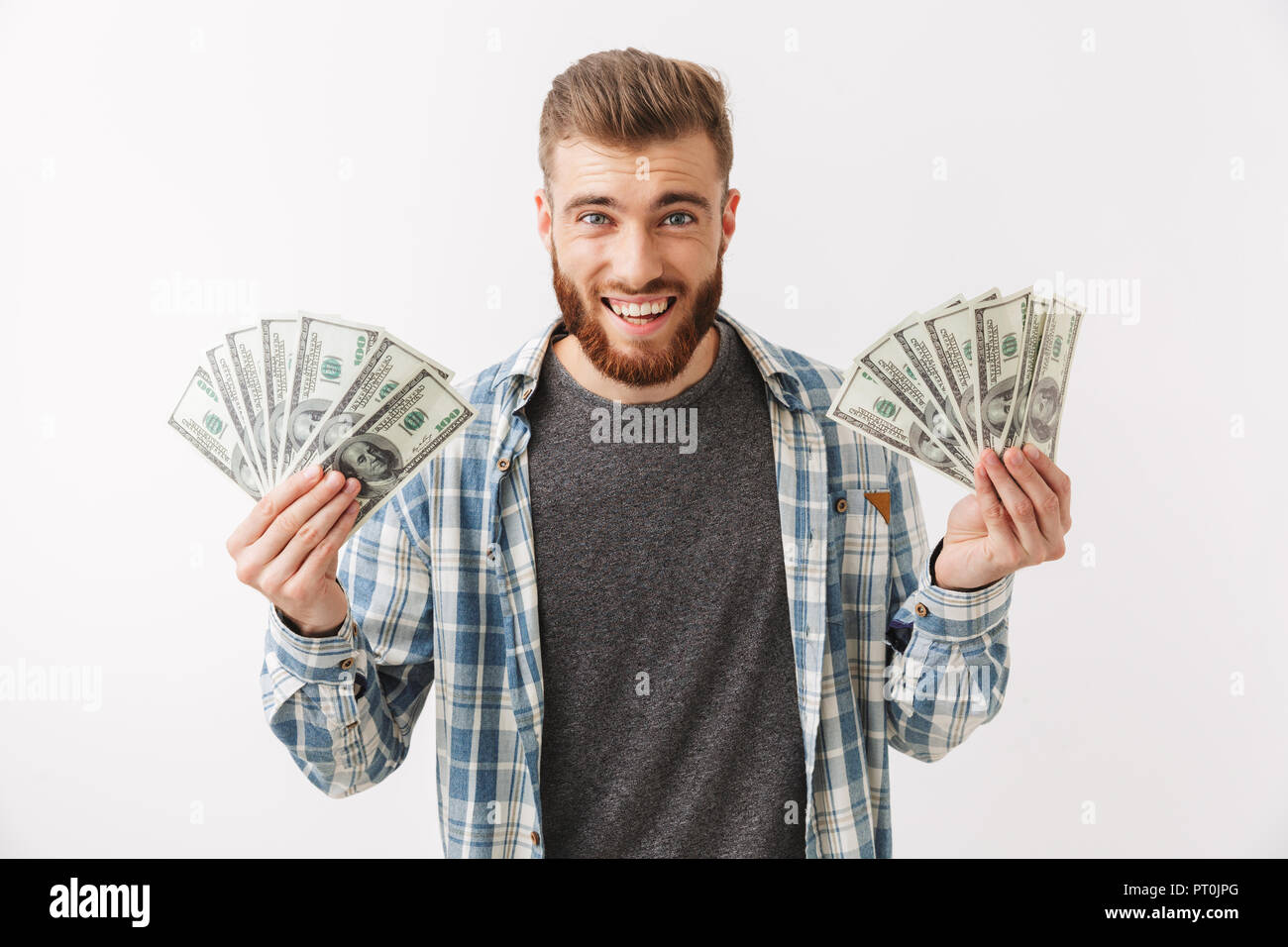 Portrait of a happy young bearded man standing isolated over white ...