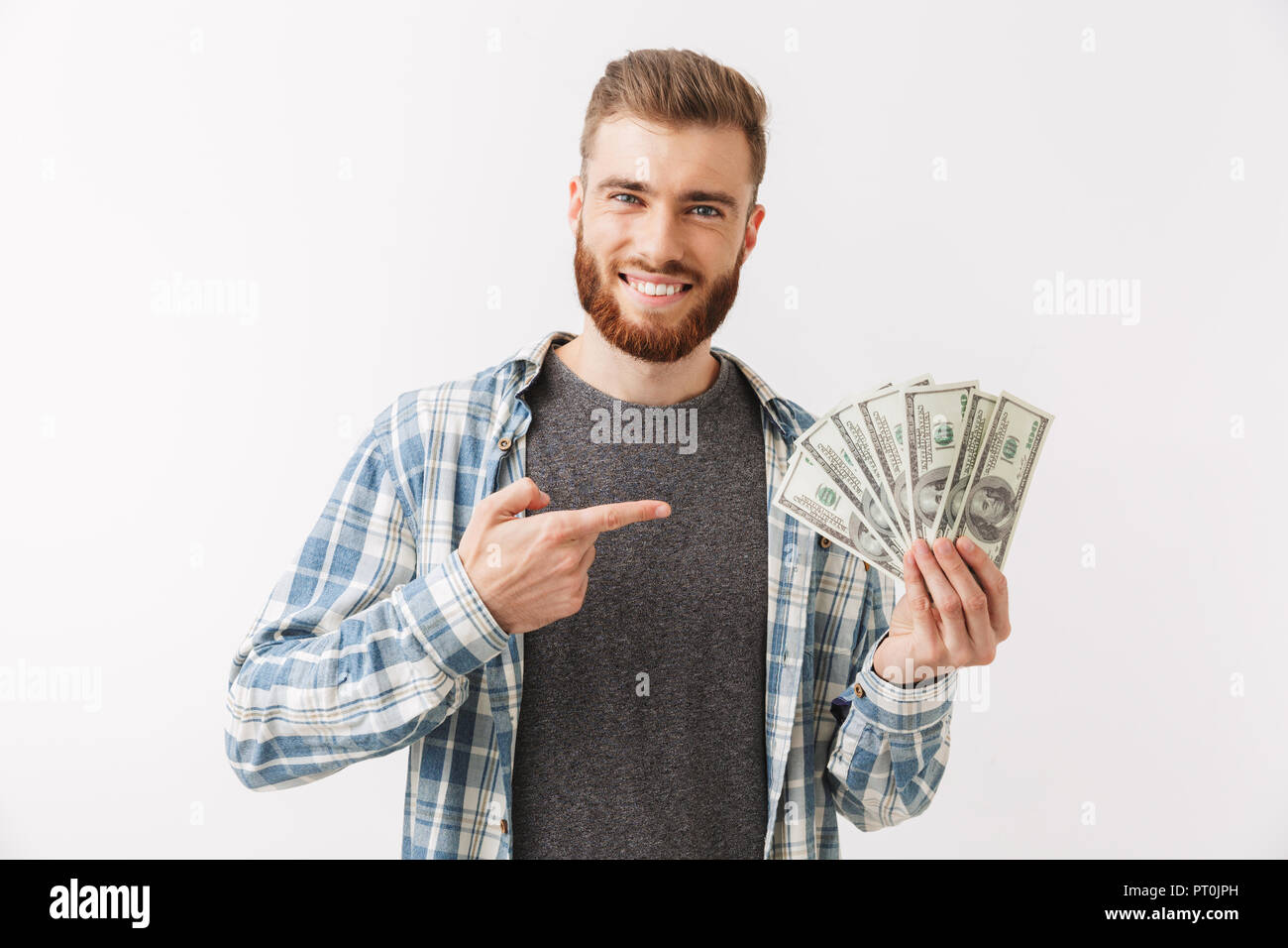 Portrait of a cheerful young bearded man standing isolated over white ...