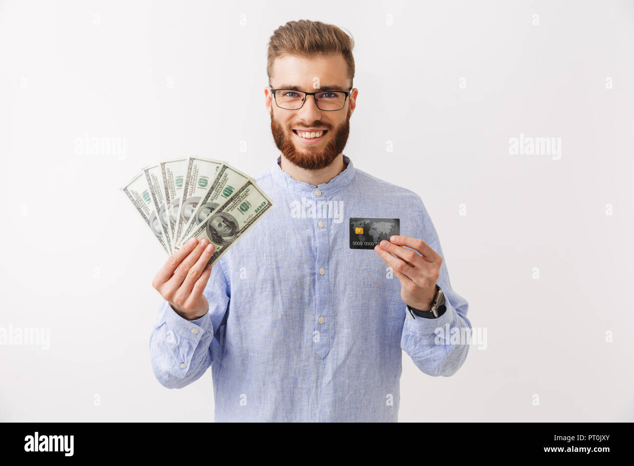 Portrait of a smiling young bearded man standing isolated over white ...