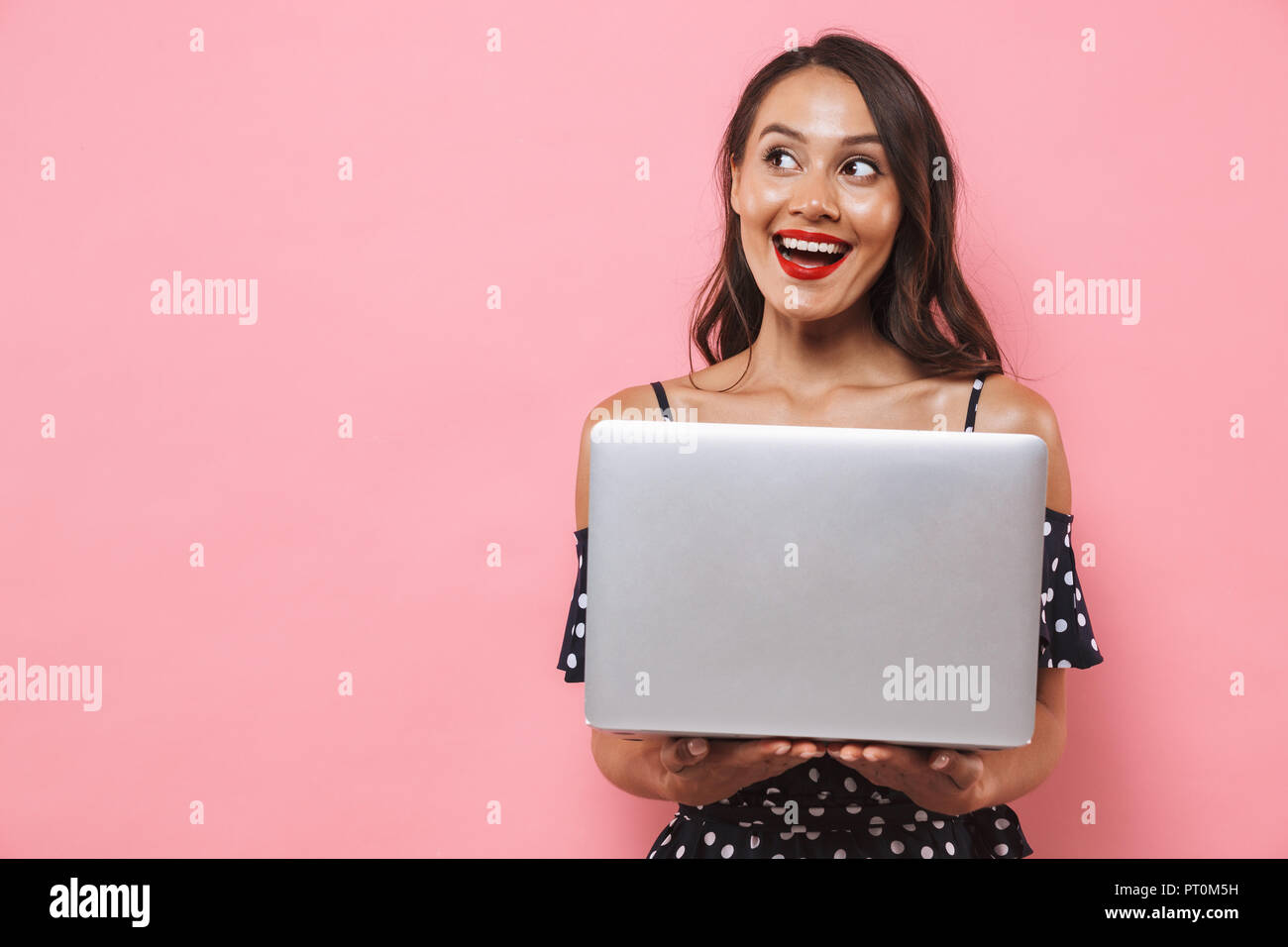 Photo of happy beautiful woman isolated over pink background using ...