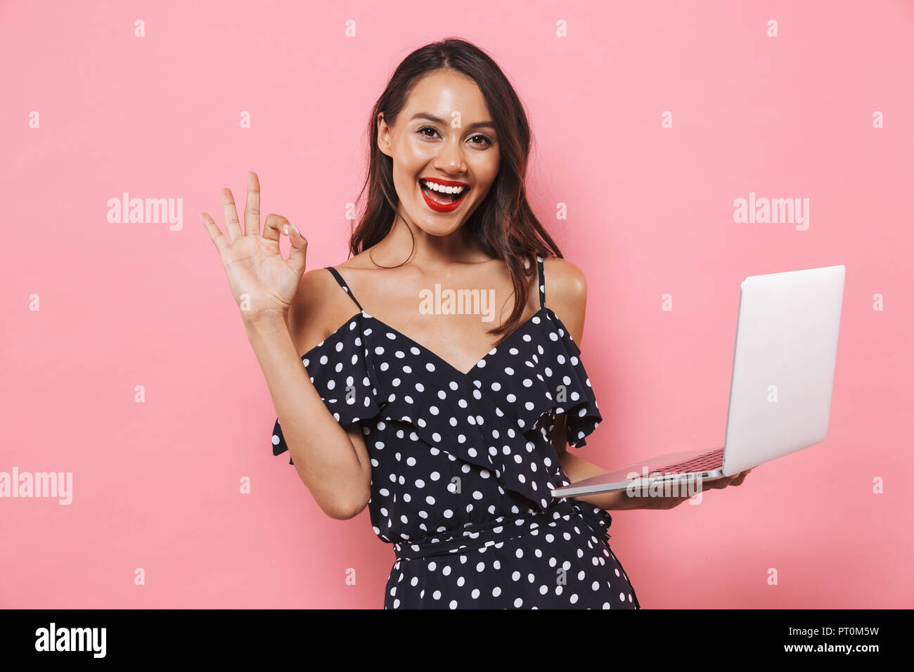 Photo of happy beautiful woman isolated over pink background using ...