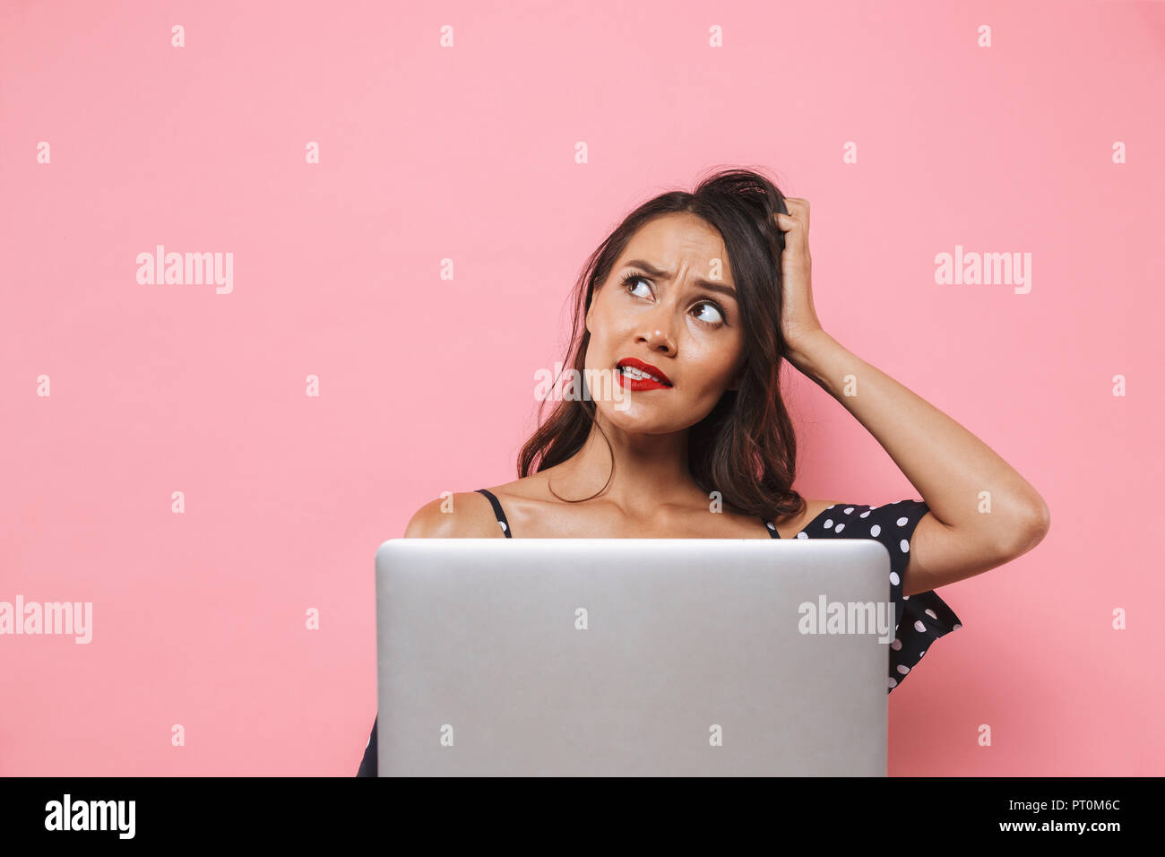 Photo of confused displeased beautiful woman isolated over pink ...