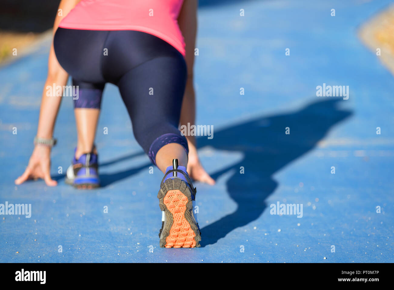 Portrait of beautiful woman ready to start running, back view Stock ...
