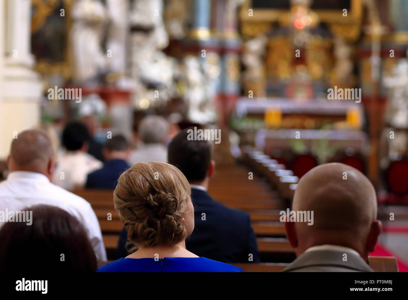 People are sitting in the church during mass and empty space for text ...
