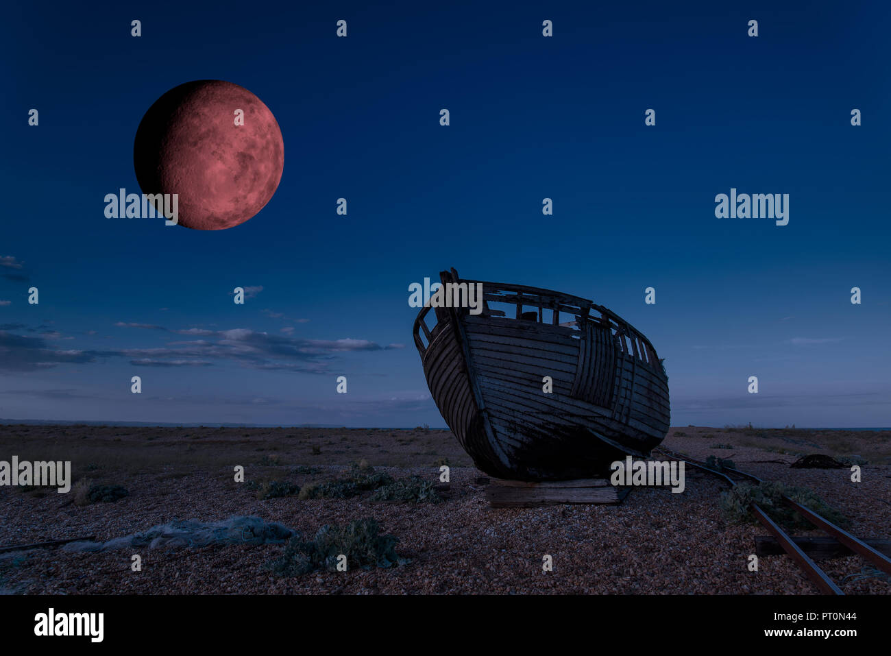Digital composite image of Blood Moon over Abandoned fishing boat on ...