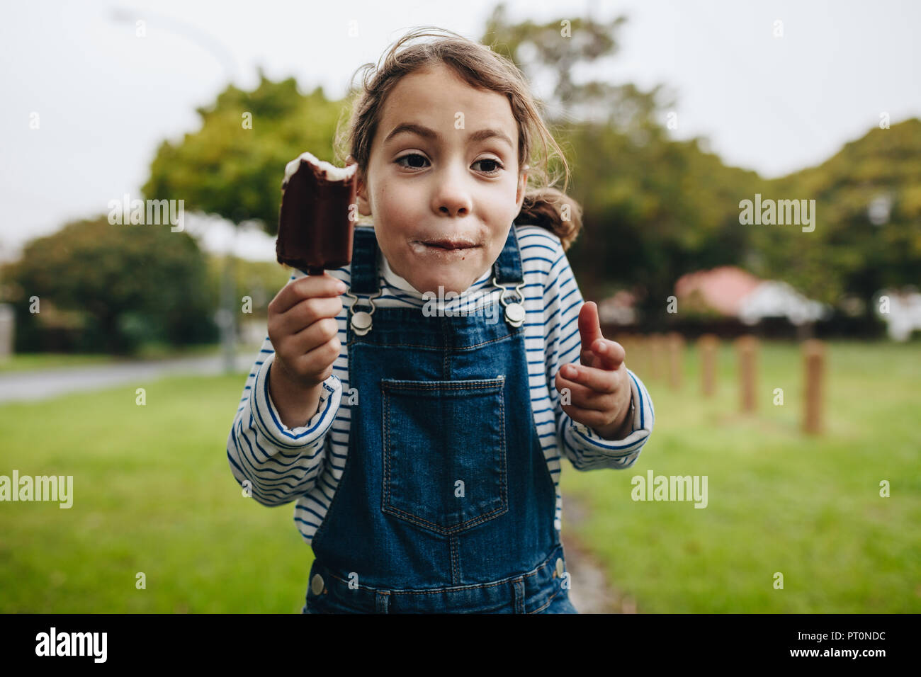 Portrait of adorable little girl enjoying eating ice cream. Cute young ...