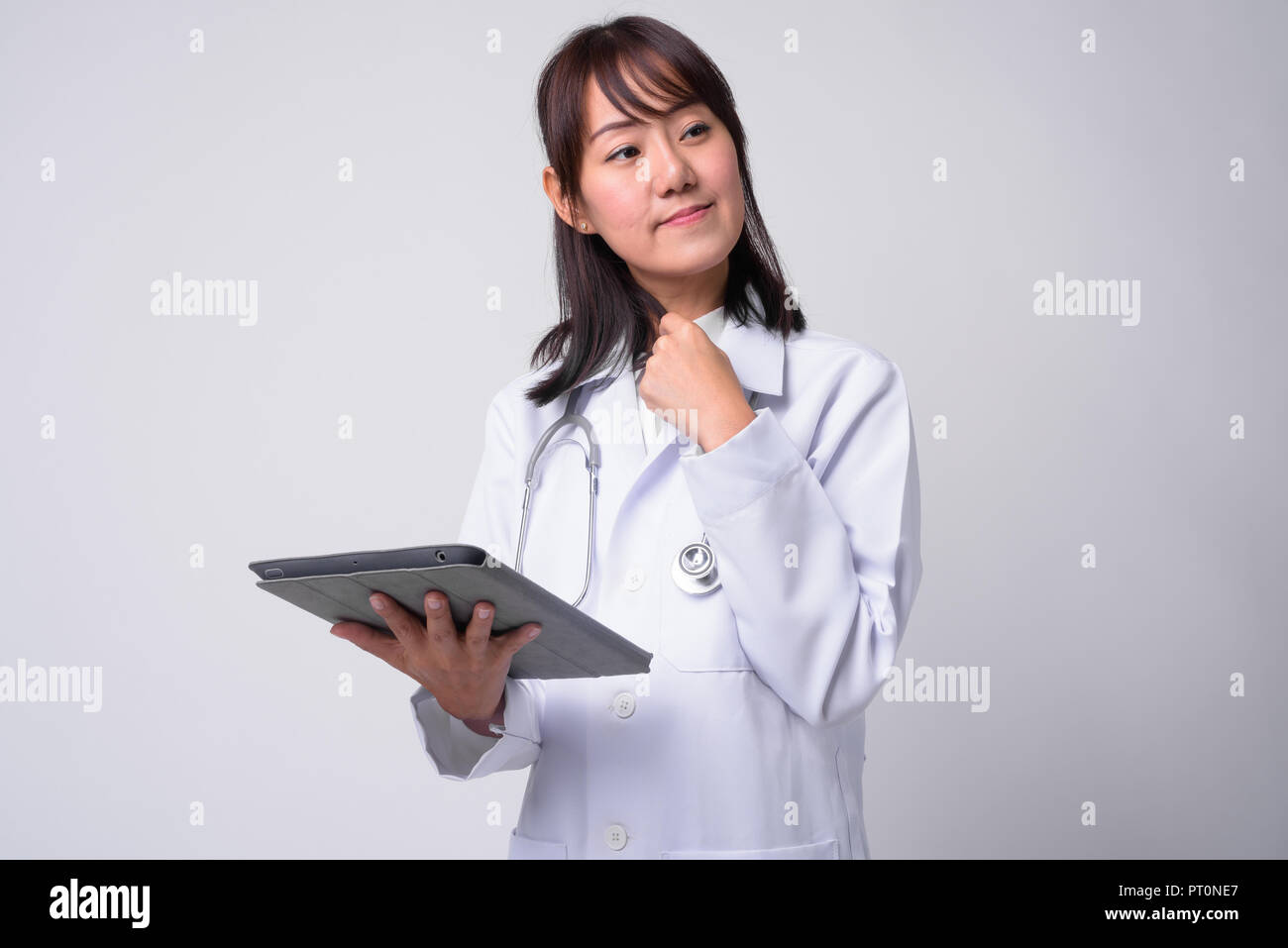 Portrait of beautiful Asian woman doctor against white background Stock ...