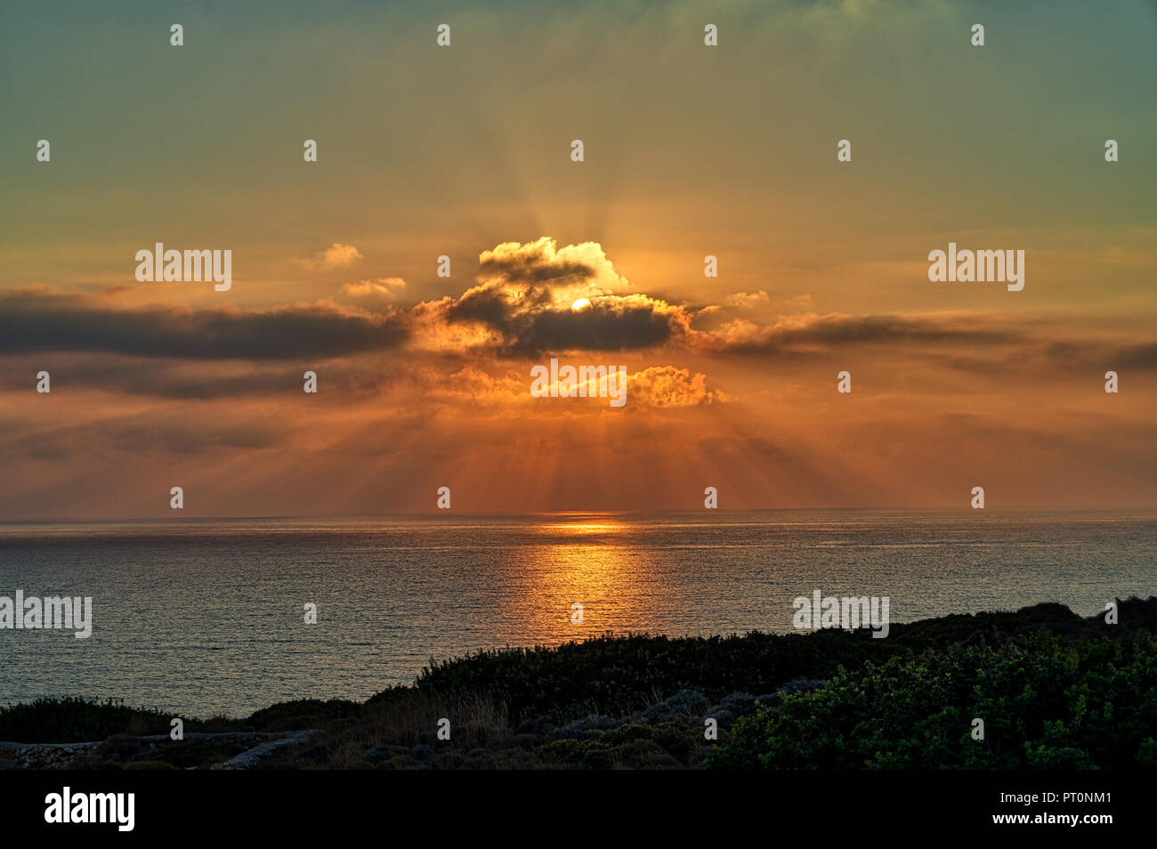 sunset over the sea with dramatic clouds Stock Photo - Alamy