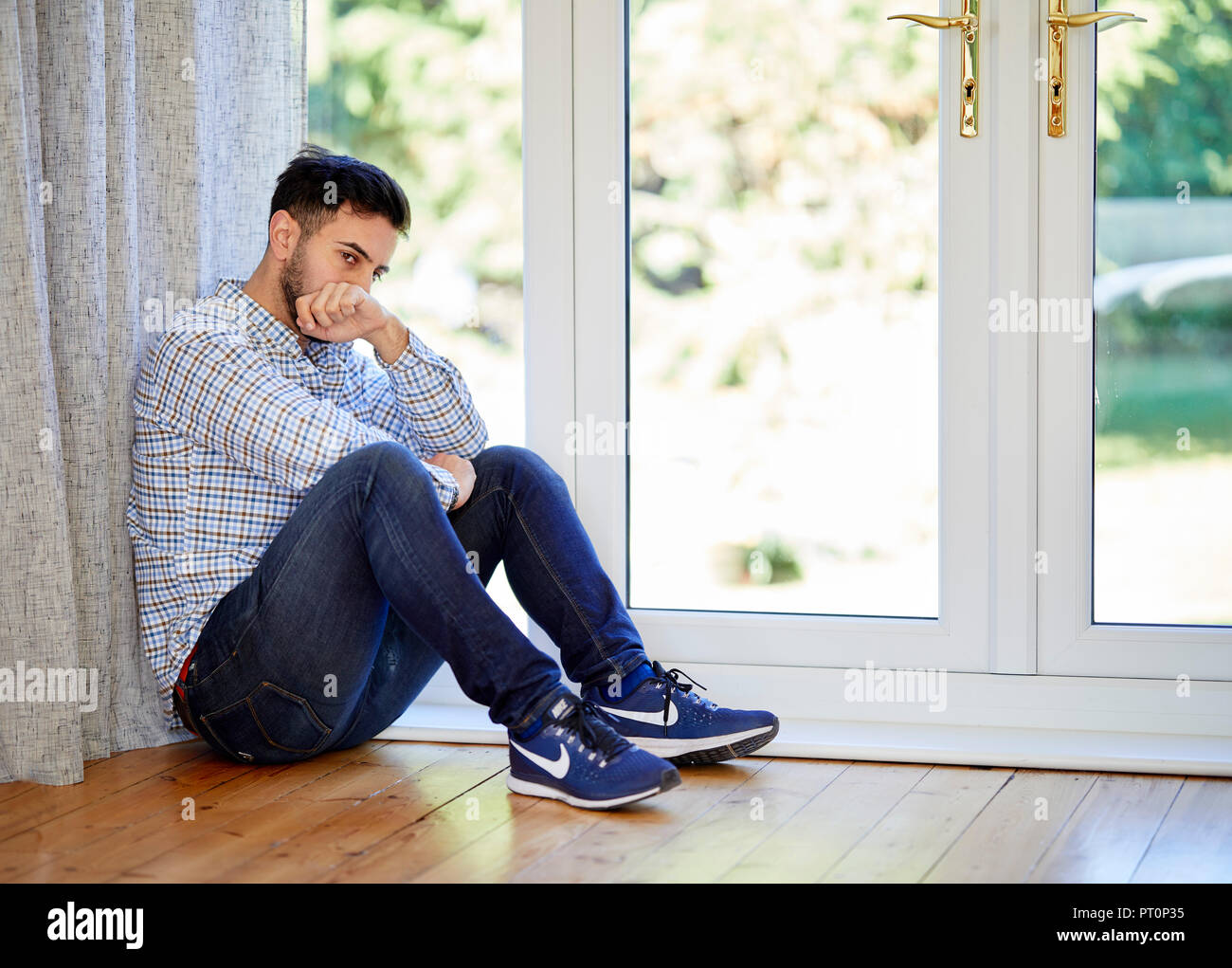 Stressed man sat on the floor Stock Photo - Alamy
